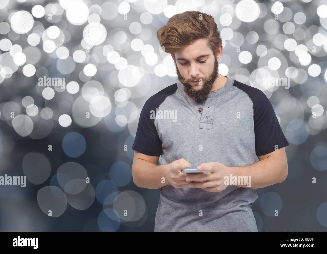 Man texting in colored lights background Stock Photo - Alamy
