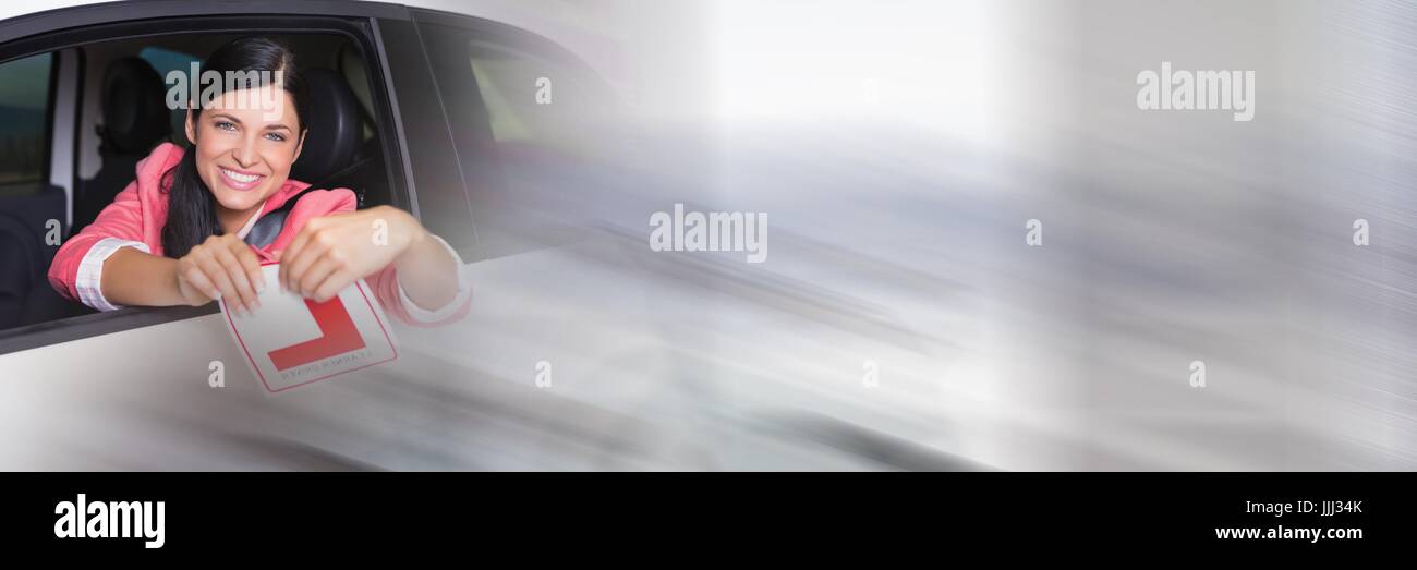 Woman In car ripping learner L sign with copy space transition Stock ...