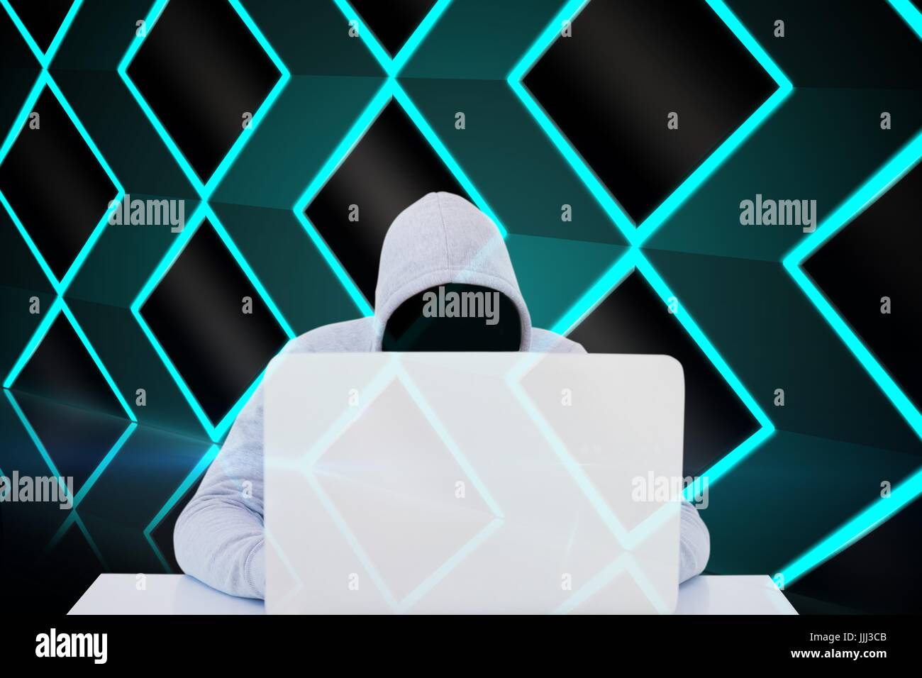 Masked hacker using a white laptop Stock Photo - Alamy