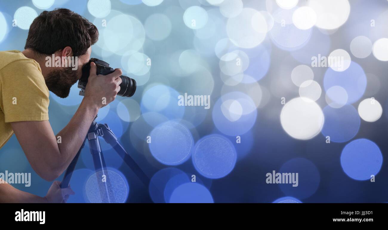 Photographer taking pictures against glowing background Stock Photo - Alamy