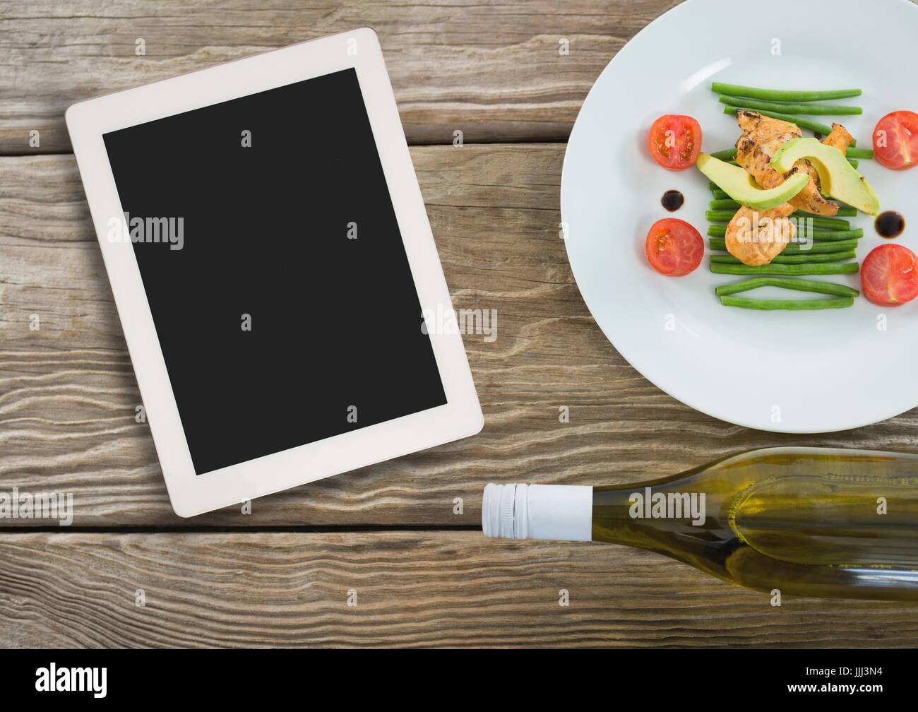 Tablet on wooden desk with food 3d Stock Photo - Alamy