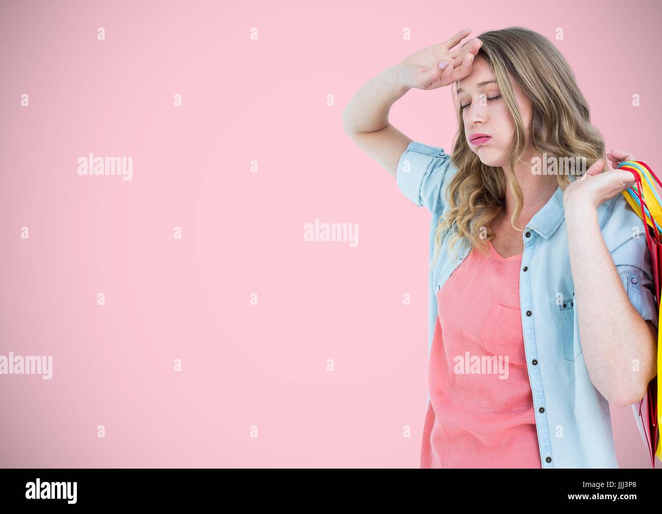 Tired shopper with bags against pink background Stock Photo - Alamy
