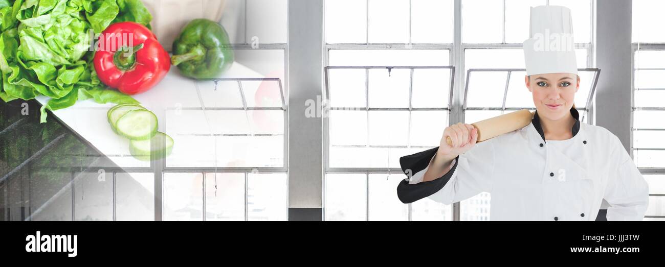Chef holding rolling pin with salad and windows background and copy ...