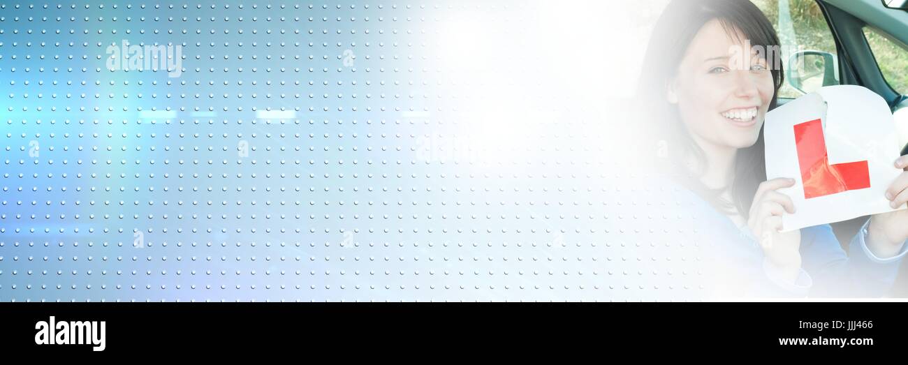 Woman In car holding learner L sign with copy space transition Stock ...