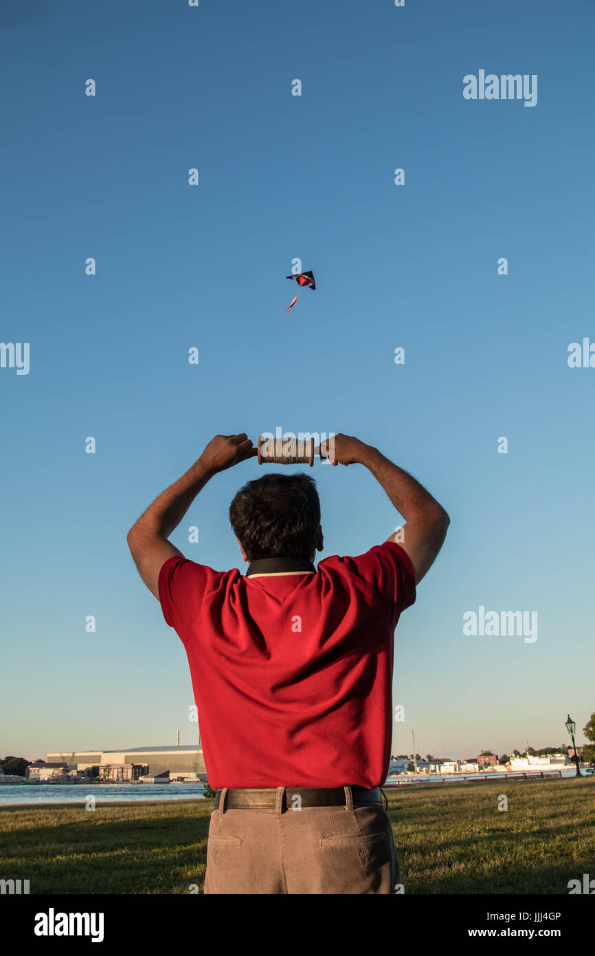 An adult flying kite in the sky Stock Photo - Alamy
