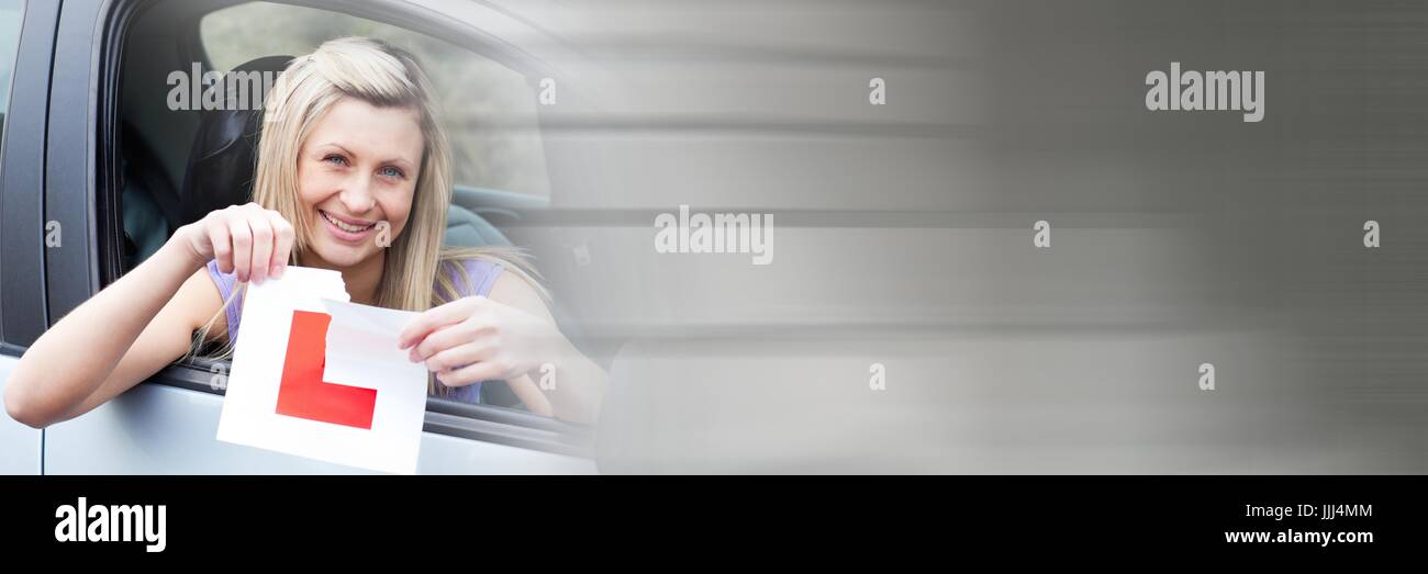 Woman In car holding L sign ripping with transition Stock Photo - Alamy