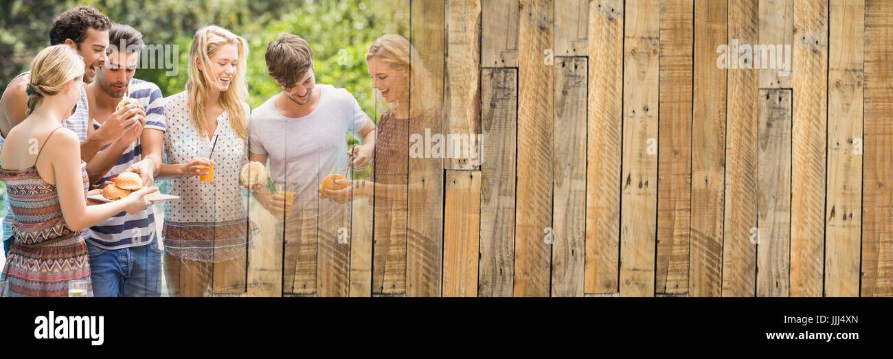Millennials laughing and eating at bbq with wood panel transition Stock ...
