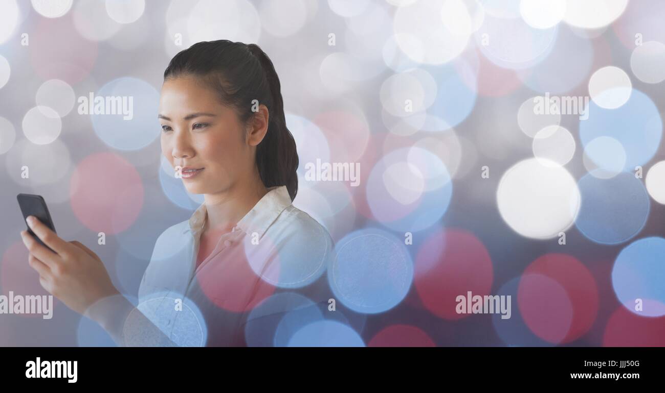Smiling woman texting in lights Stock Photo - Alamy