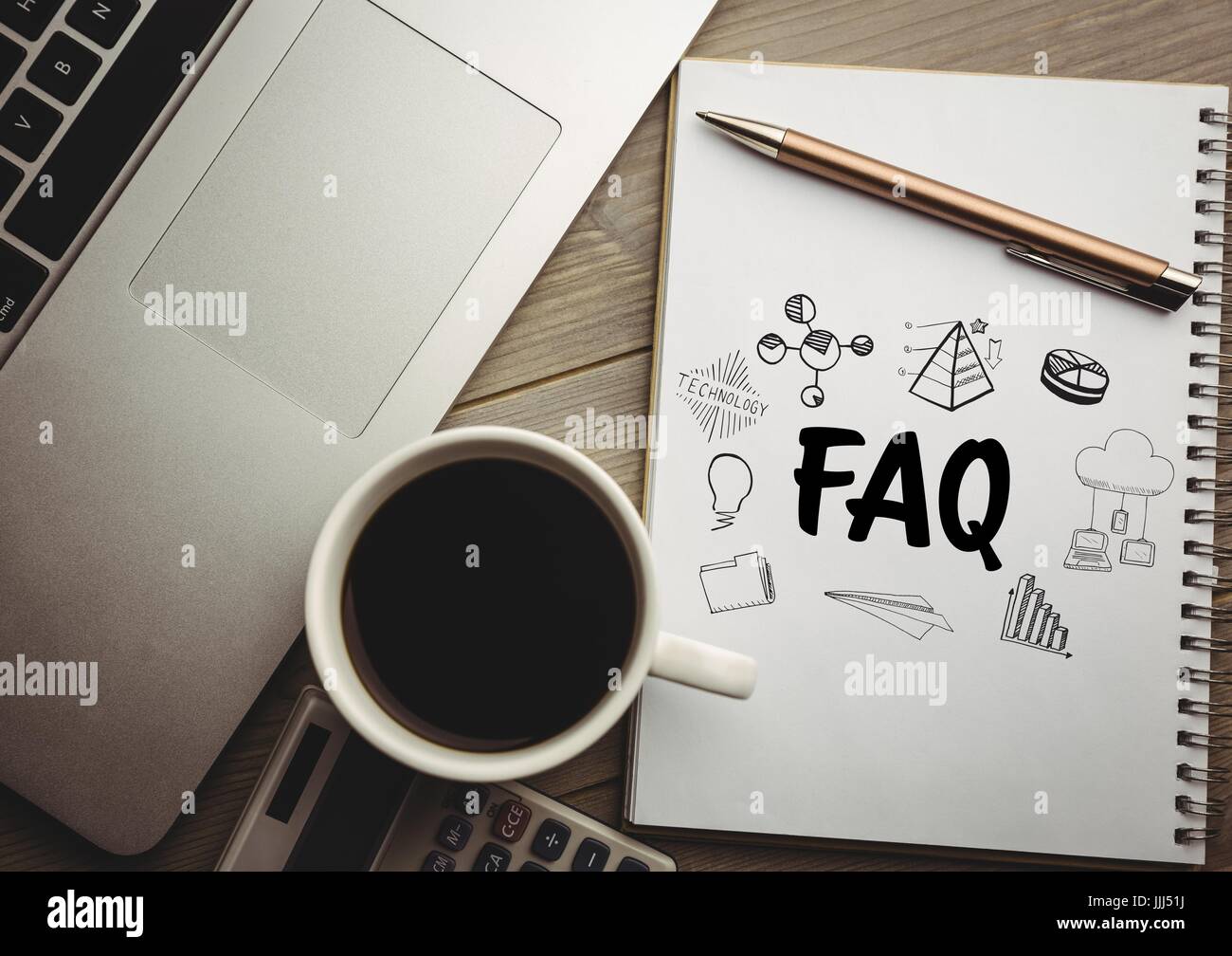 FAQ doodle on notepad next to coffee and laptop Stock Photo - Alamy