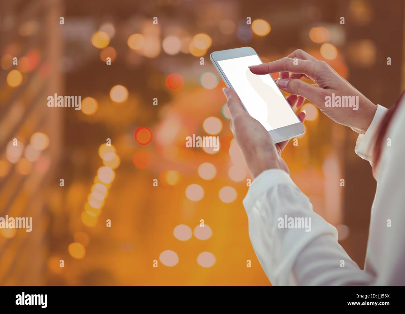 Part of woman texting against city background Stock Photo - Alamy