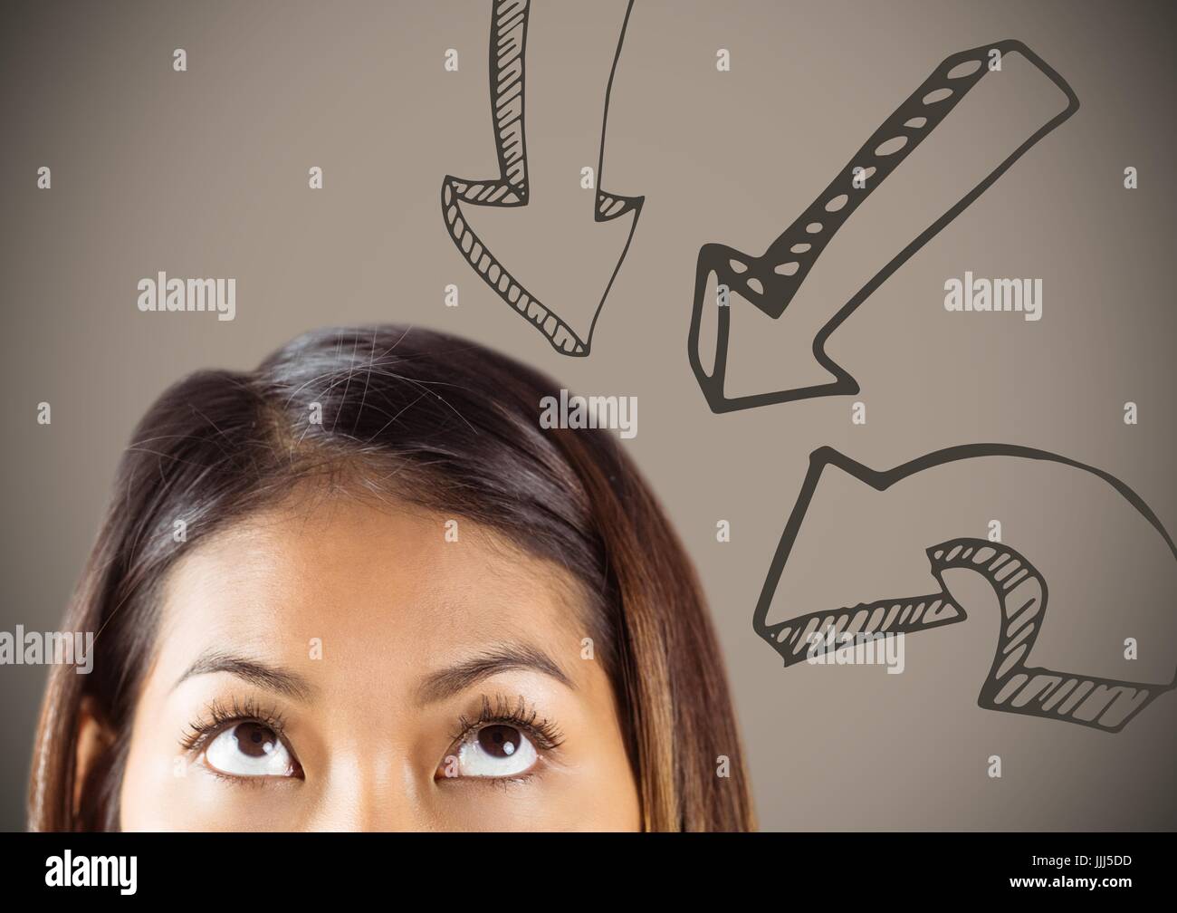 Top of woman's head looking up at downward arrows against brown ...
