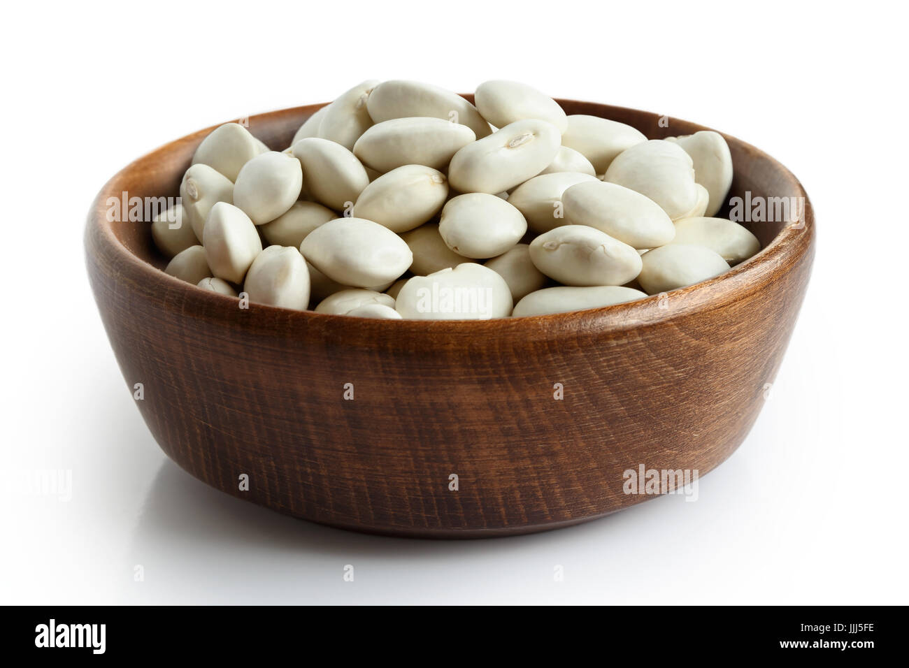 Dry butter beans in dark wooden bowl isolated on white Stock Photo - Alamy