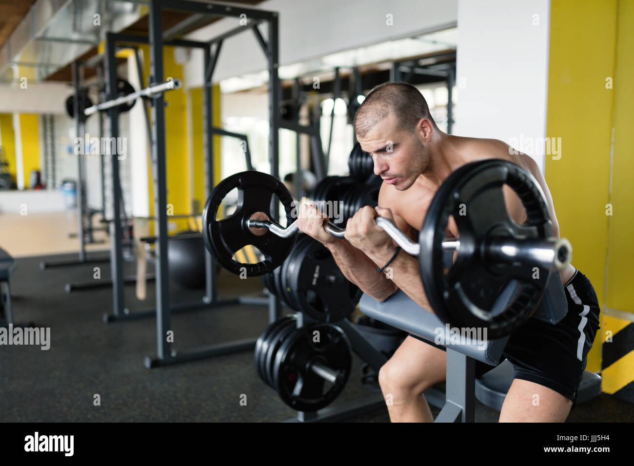 Athlete muscular bodybuilder in gym training biceps Stock Photo - Alamy