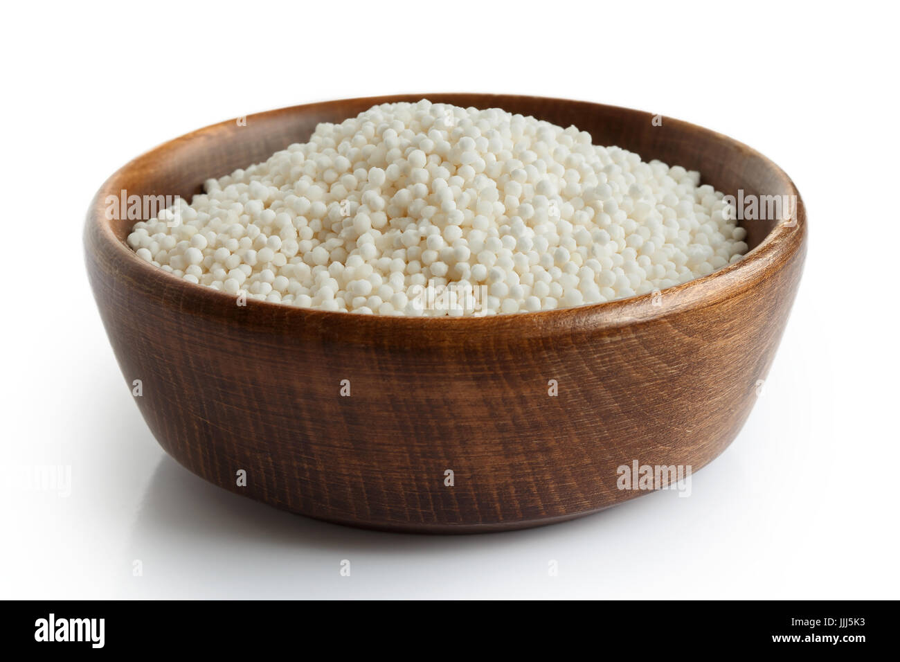 Dry tapioca pearls in dark wooden bowl isolated on white Stock Photo ...