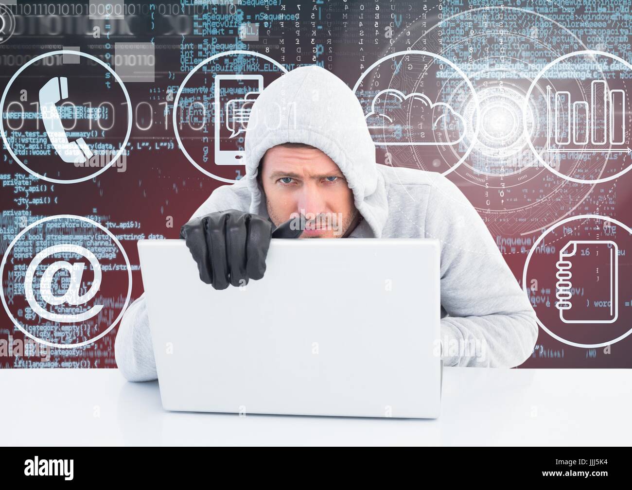 Hacker with gloves using a laptop in front of digital background Stock ...