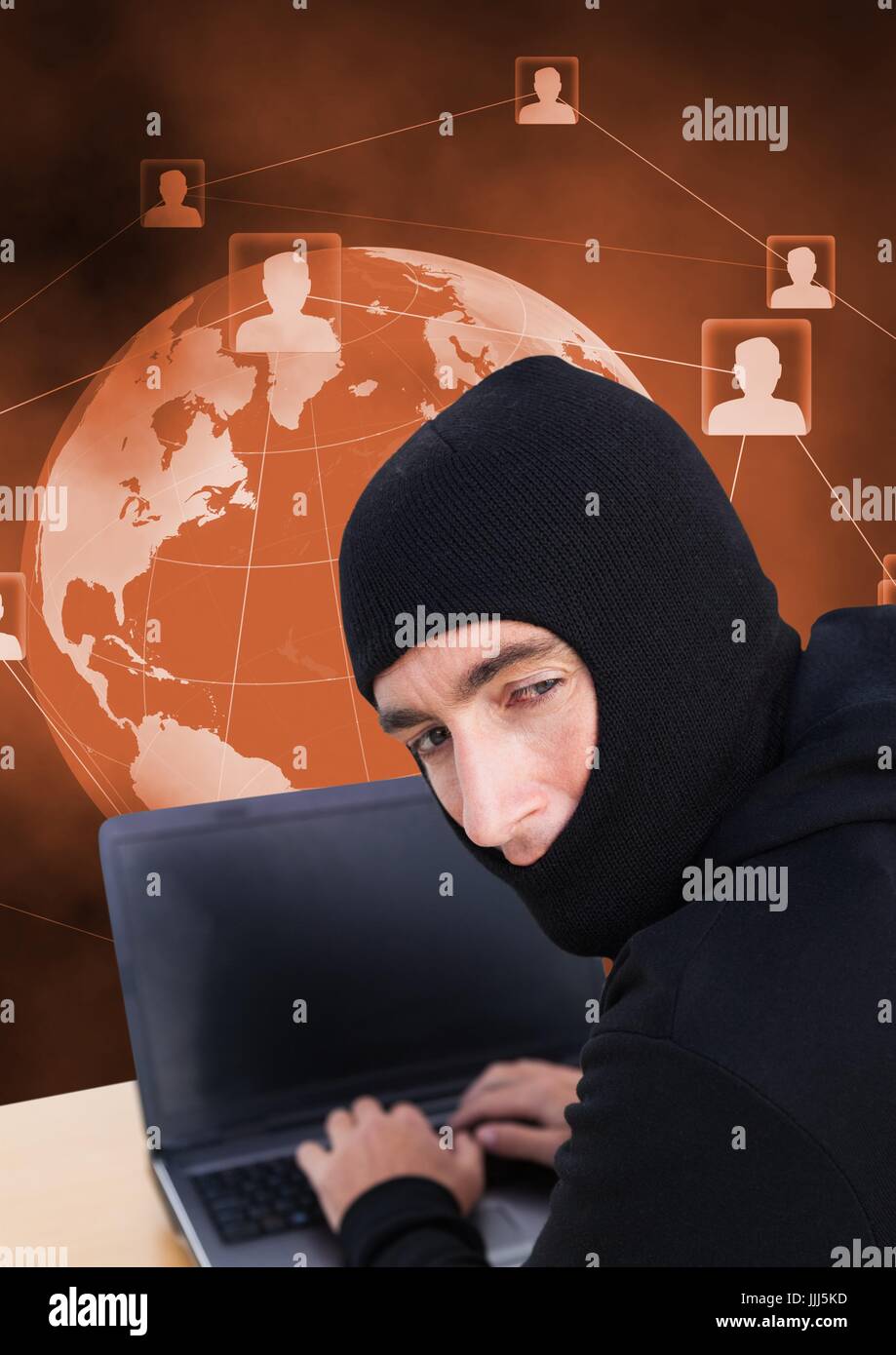 Hacker using a laptop looking at the camera Stock Photo - Alamy