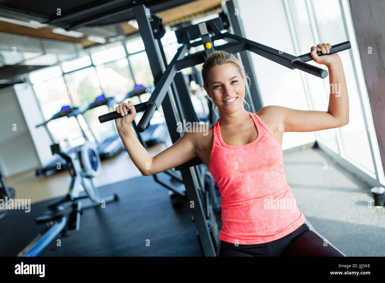 Beautiful young woman doing exercises in gym Stock Photo - Alamy