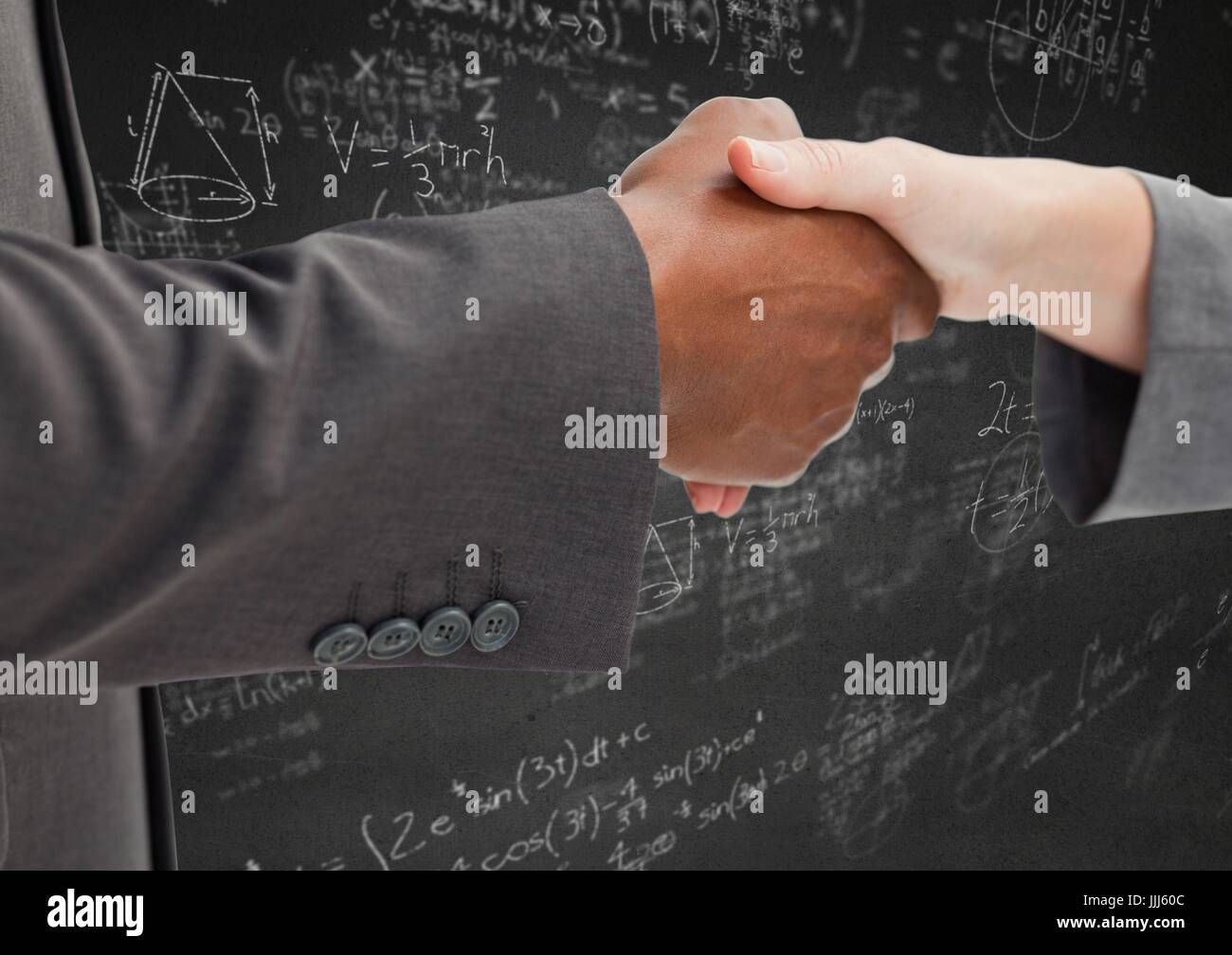 Handshake against grey wall with math doodles Stock Photo - Alamy
