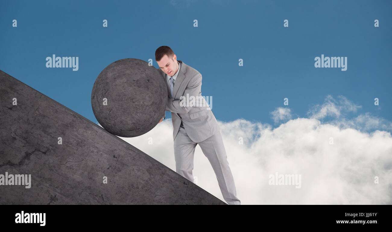 Man pushing rolling round rock Stock Photo - Alamy