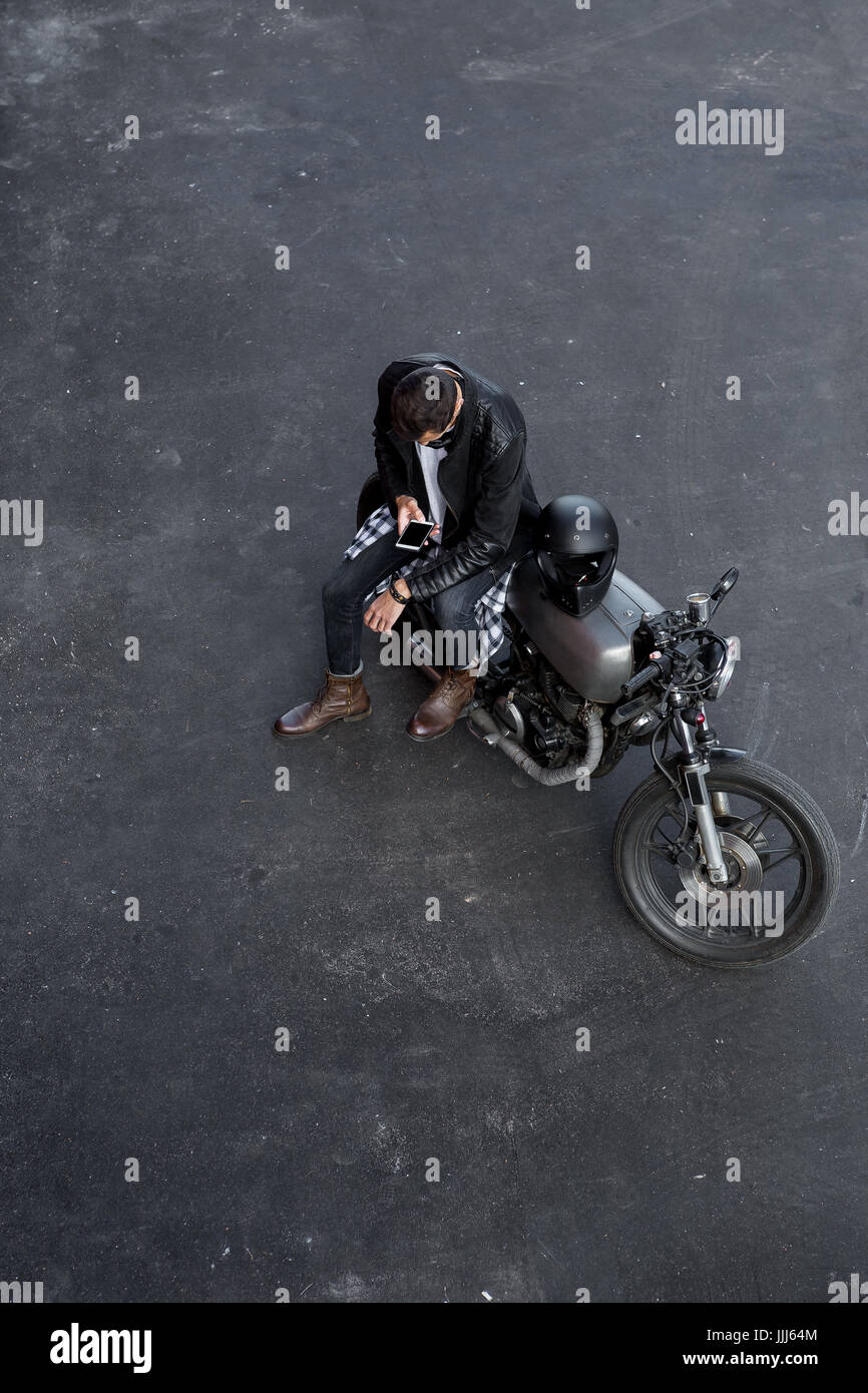 Top view of a handsome rider man in black biker jacket and check shirt ...
