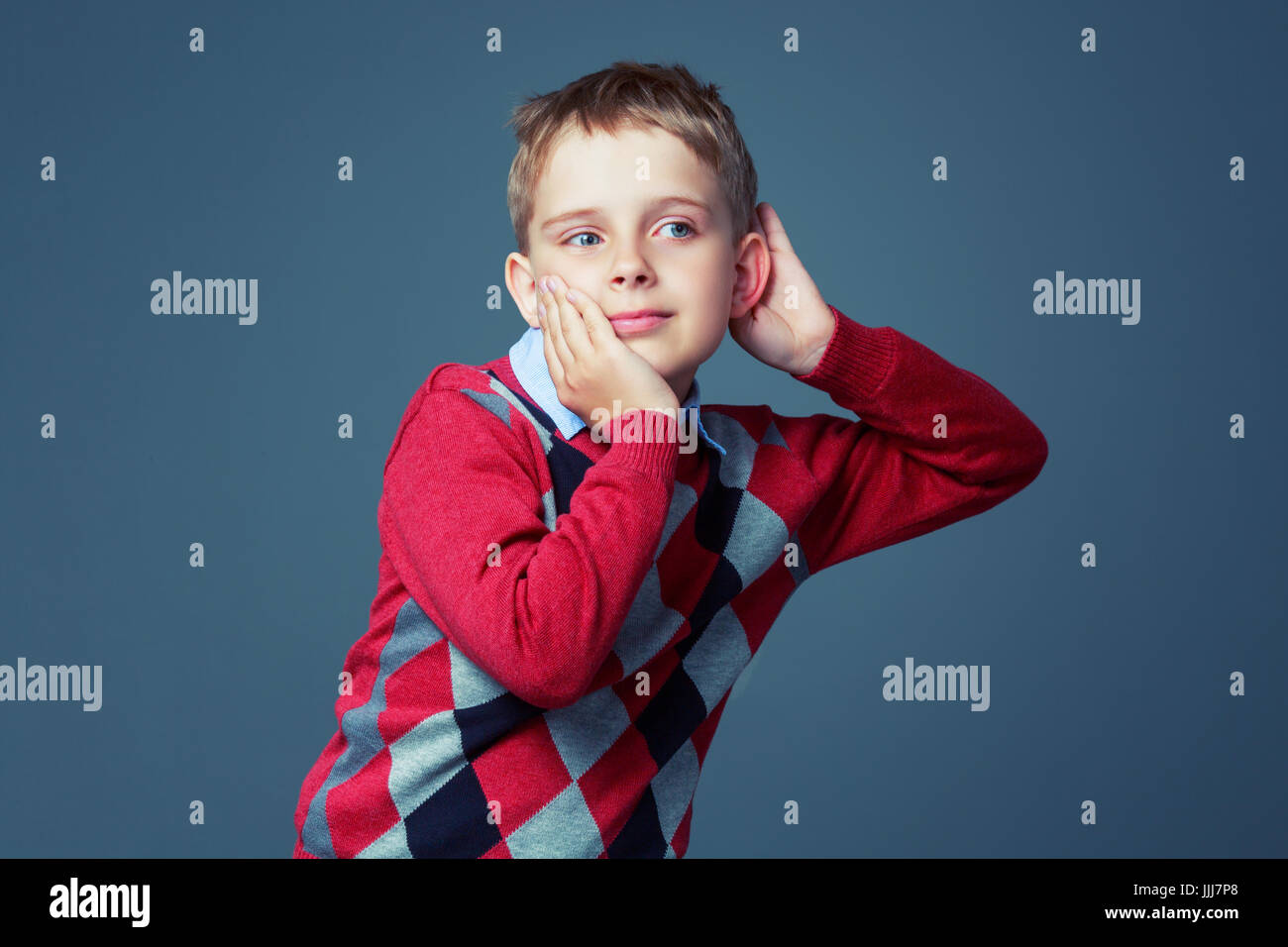 boy listening to something, isolated against grey background Stock ...