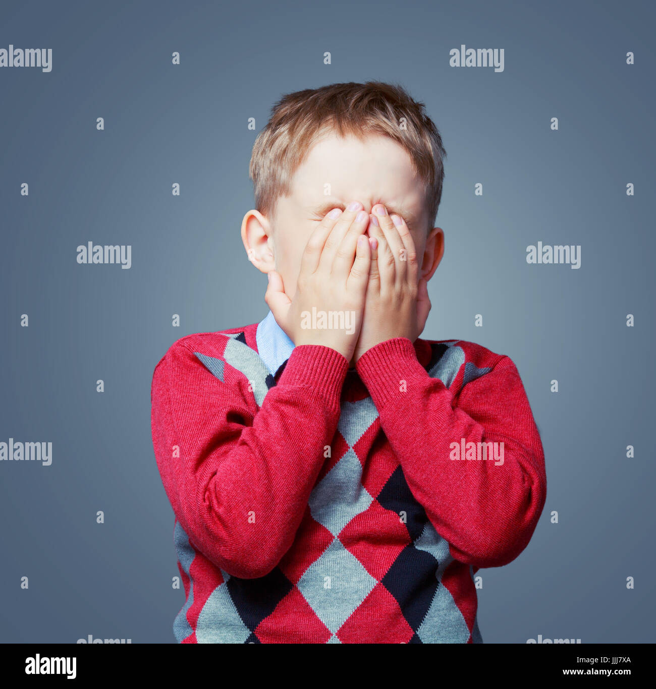 displeased crying boy isolated against grey background Stock Photo - Alamy