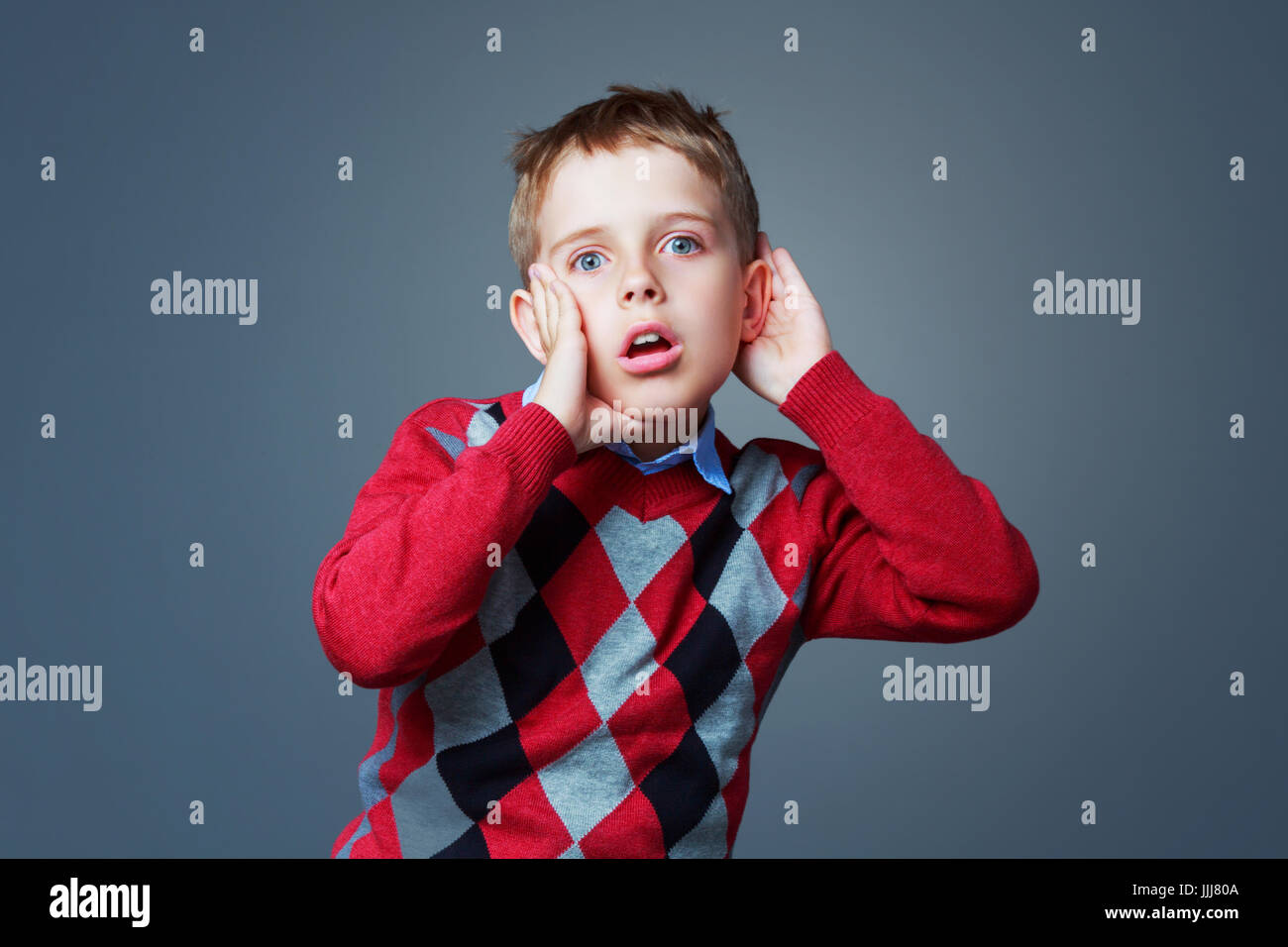 surprised boy listening to something, isolated Stock Photo - Alamy
