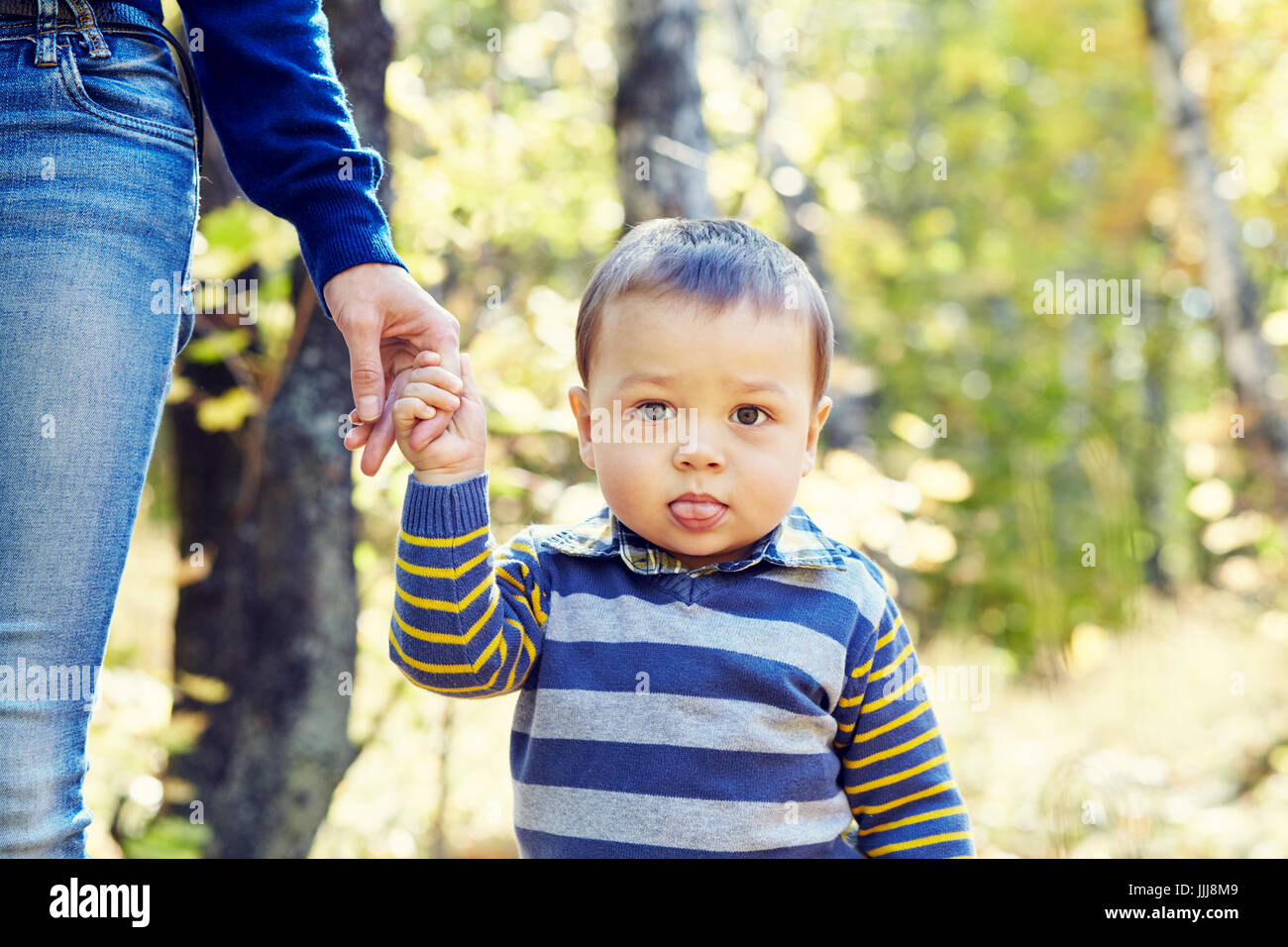 Baby walking hand in hand hi-res stock photography and images - Alamy
