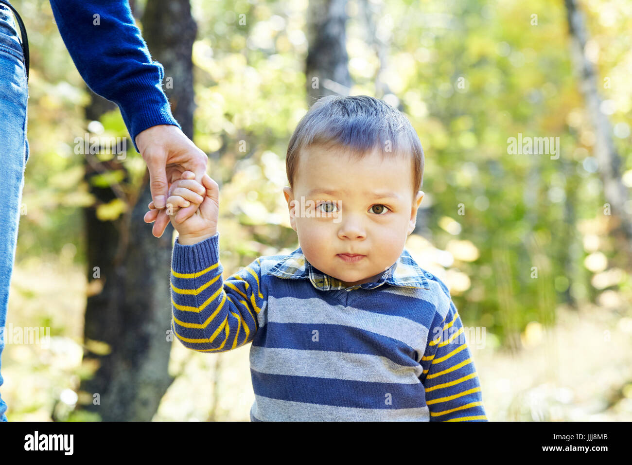 Baby walking hand in hand hi-res stock photography and images - Alamy