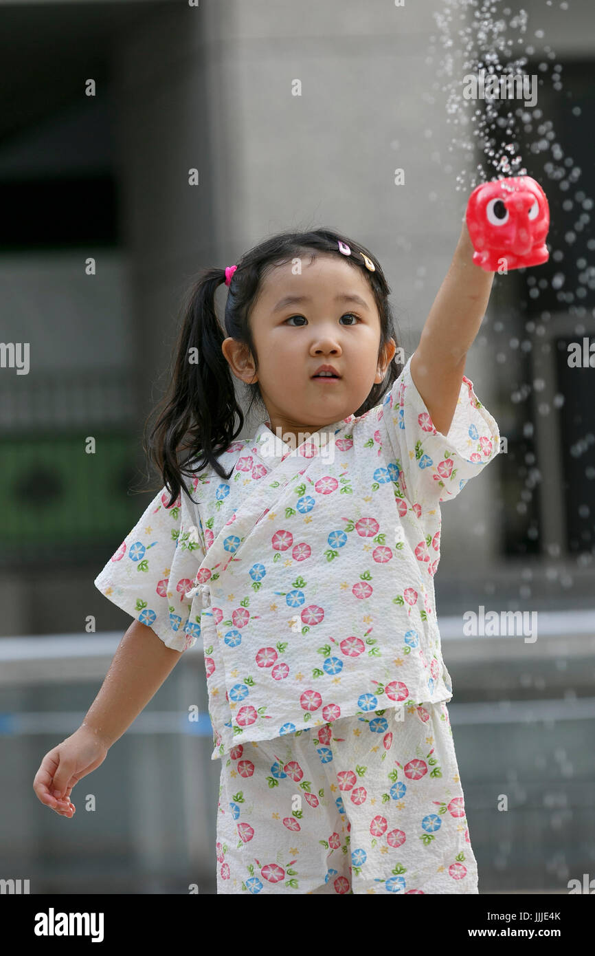 Tokyo, Japan. 20th July, 2017. A girl enjoys sprinkling water during ...