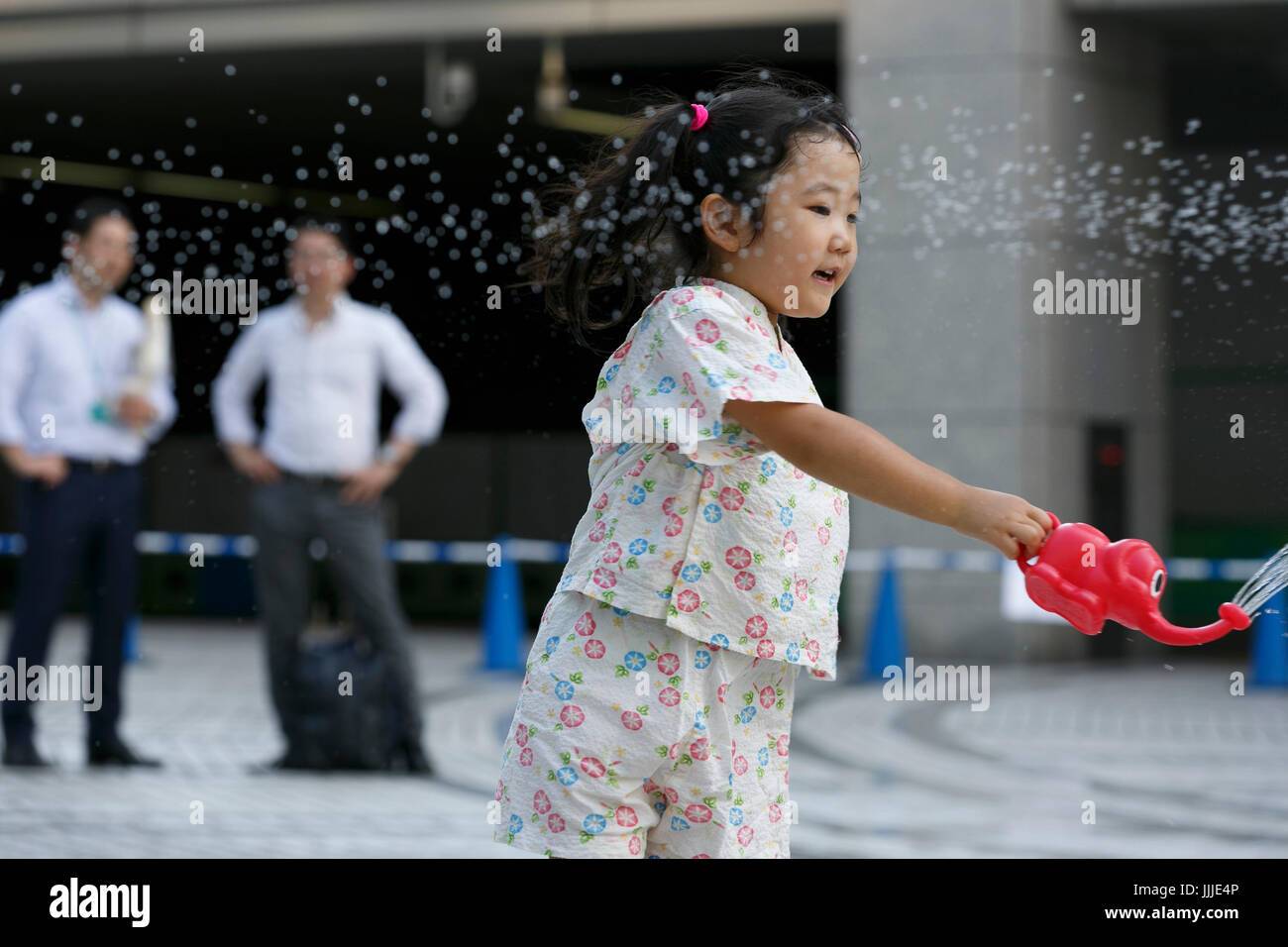 Tokyo, Japan. 20th July, 2017. A girl enjoys sprinkling water during ...