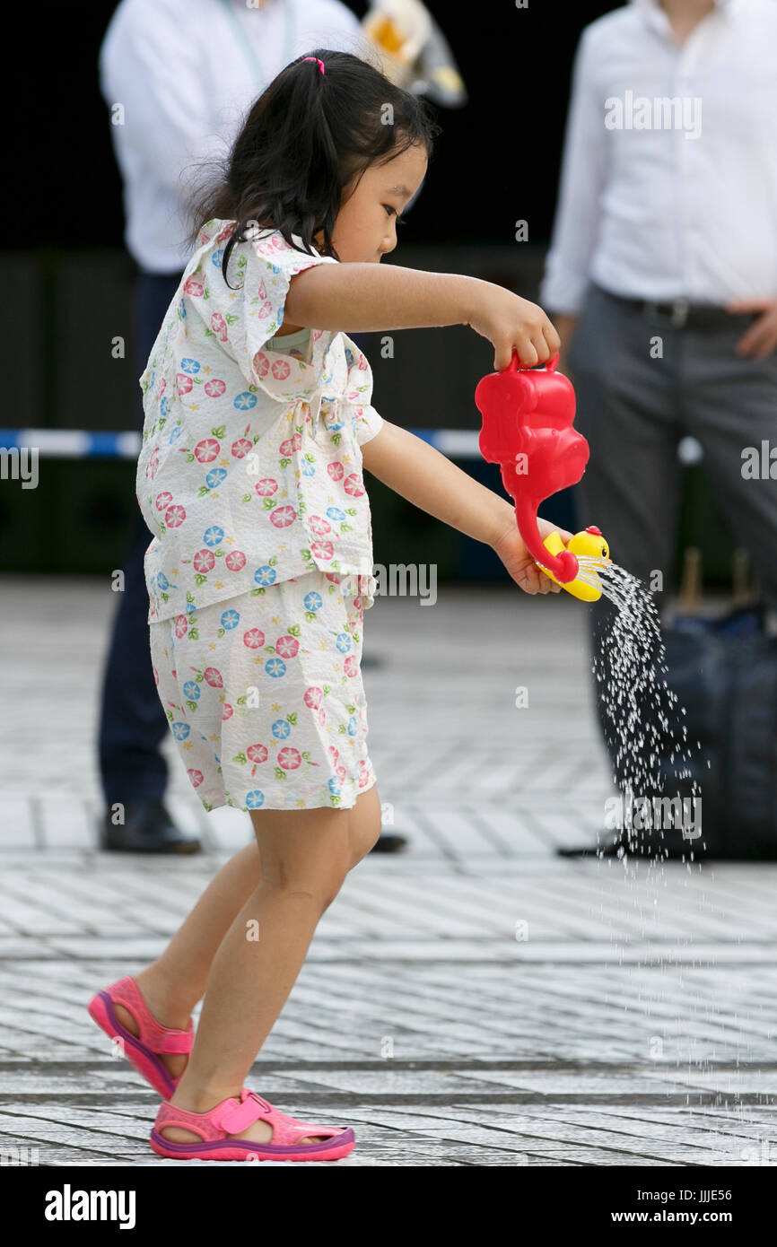Tokyo, Japan. 20th July, 2017. A girl enjoys sprinkling water during ...