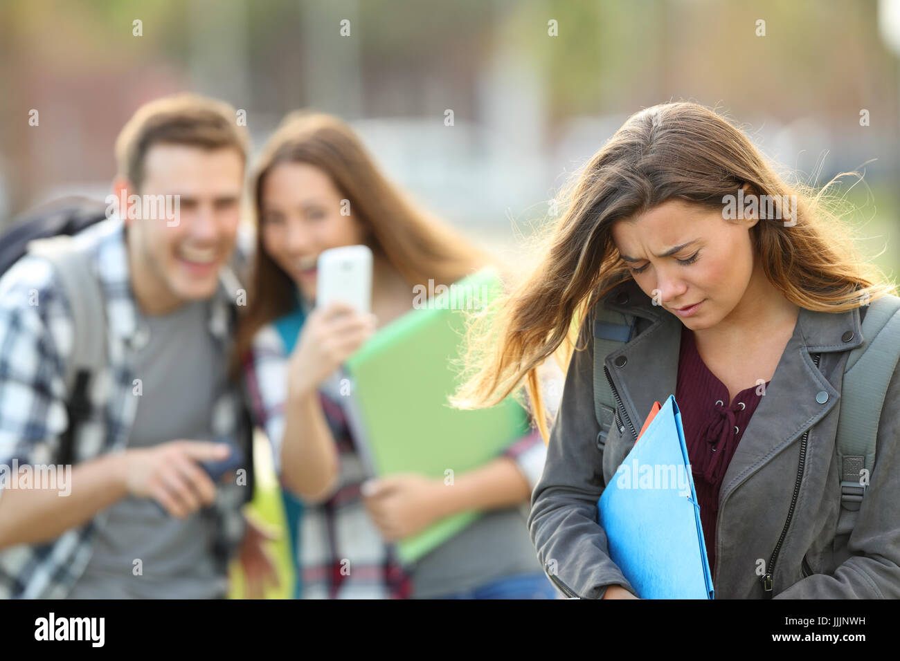 Bullying victim being video recorded on a smartphone by classmates in ...