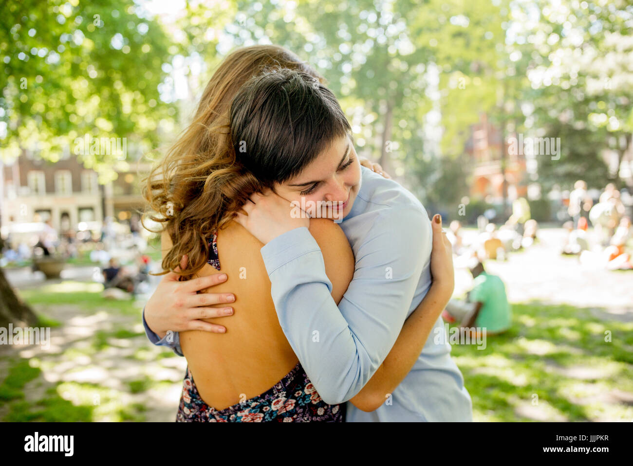 A young lesbian couple hug each other in the park Stock Photo - Alamy