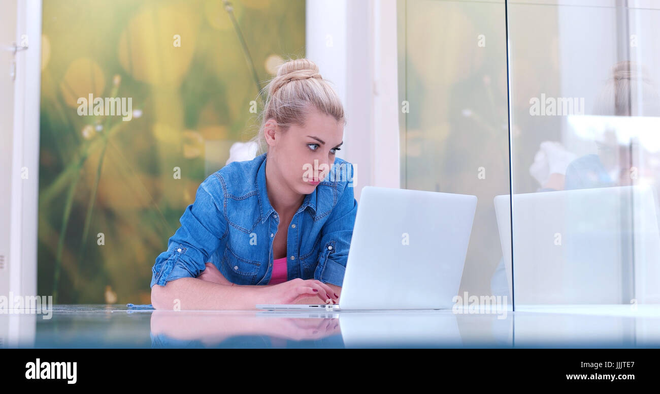 beautiful young women using laptop computer on the floor of her luxury ...