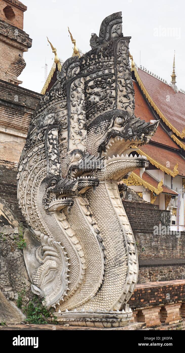 Naga, serpent snake sculpture statue at the staircase to and old pagoda ...