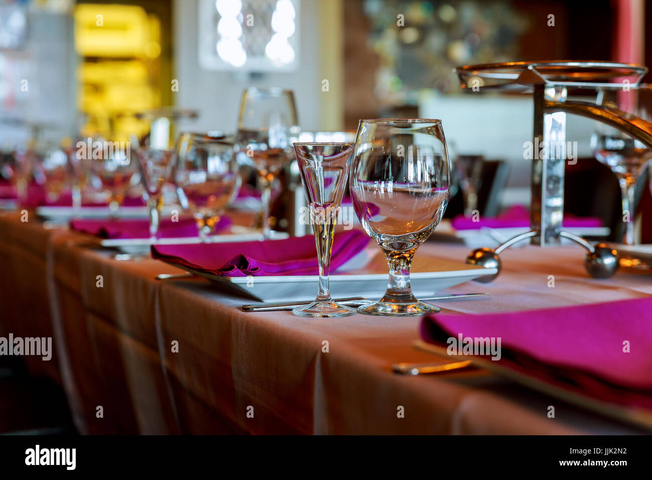 Room with served tables in restaurant, focus on glass in center Stock ...