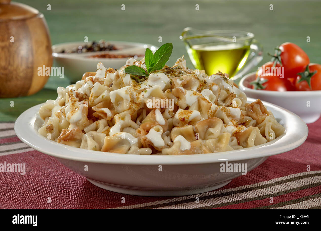 Manti,Turkish Manti manlama on plate with red pepper, tomatoes sauce ...