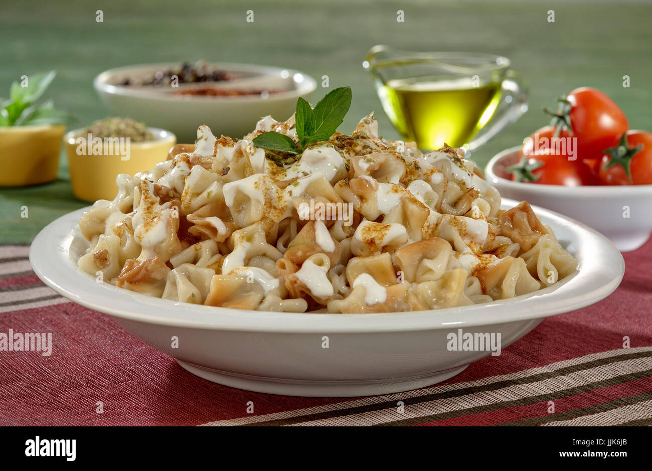 Manti,Turkish Manti manlama on plate with red pepper, tomatoes sauce ...