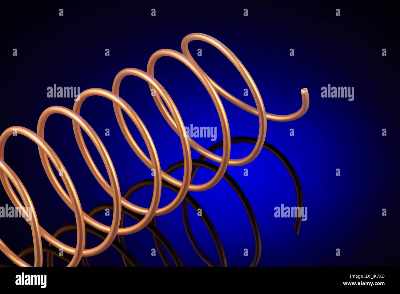 Spiral of copper wire on metal surface abstract industry Stock Photo ...