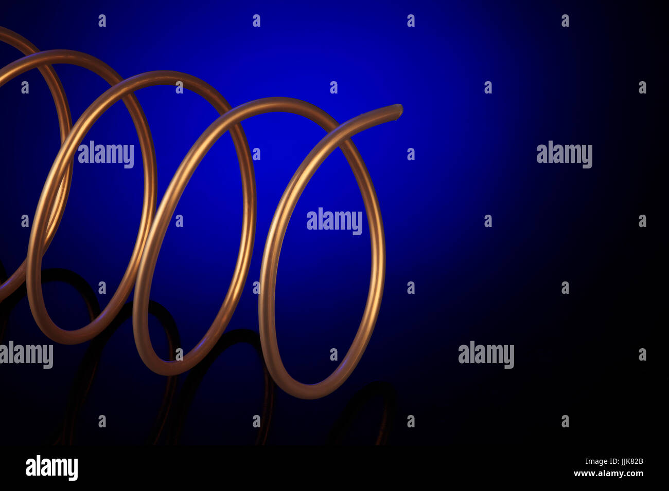 Spiral of copper wire on metal surface abstract industry Stock Photo ...