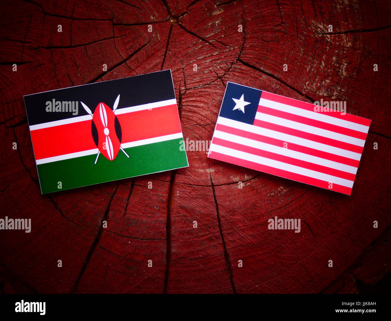 Kenyan flag with Liberian flag on a tree stump isolated Stock Photo - Alamy