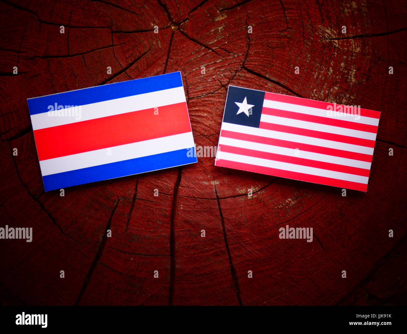Costa Rican flag with Liberian flag on a tree stump isolated Stock ...