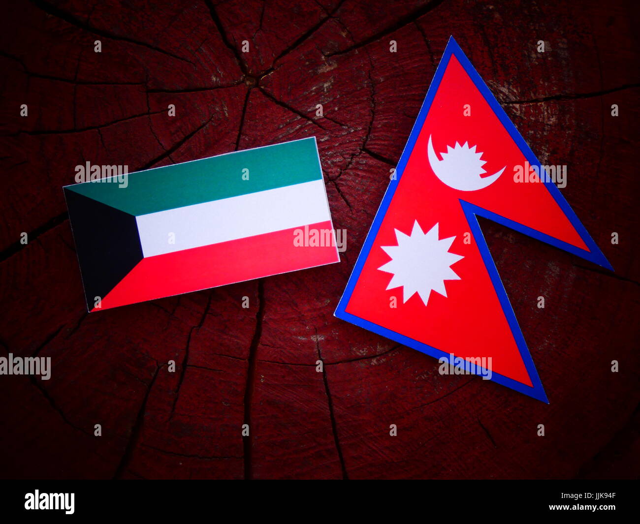 Kuwaiti flag with Nepali flag on a tree stump isolated Stock Photo - Alamy