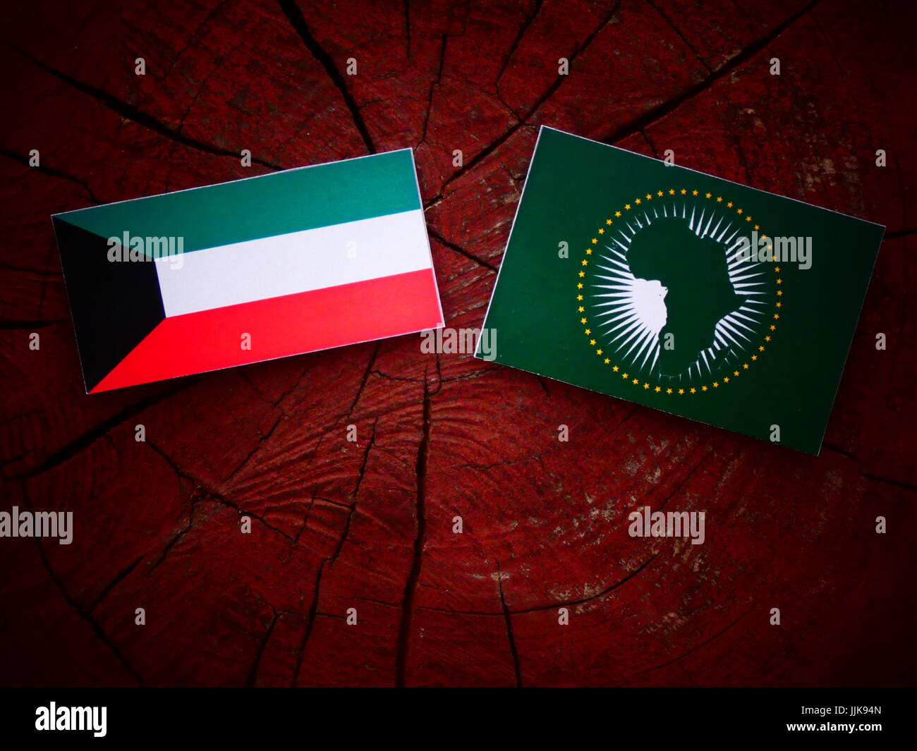 Kuwaiti flag with African Union flag on a tree stump isolated Stock ...