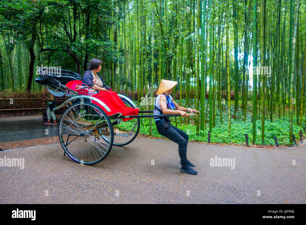 KYOTO, JAPAN - JULY 05, 2017: Unidentified people in a red rickshaw ...
