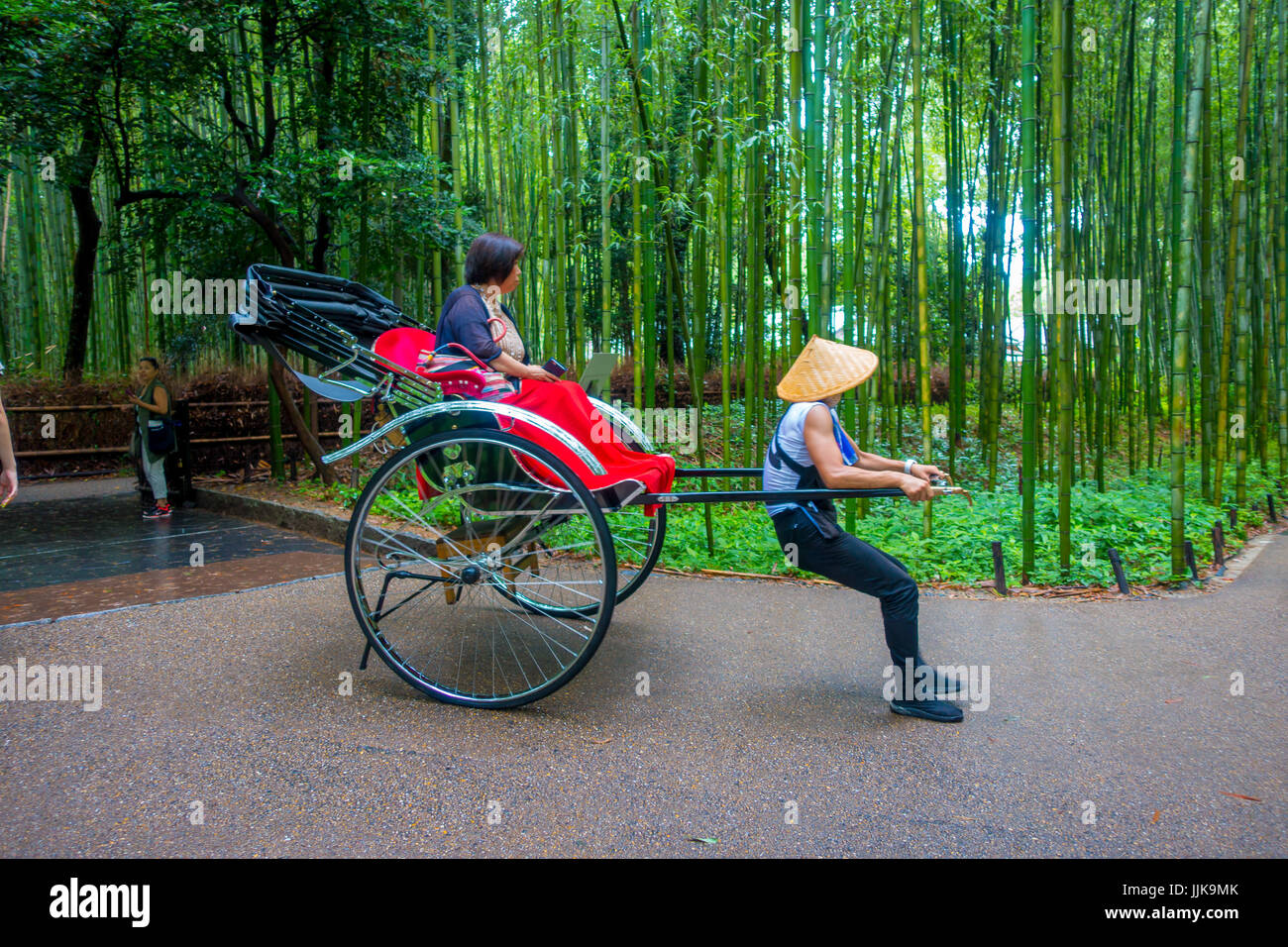 KYOTO, JAPAN - JULY 05, 2017: Unidentified people in a red rickshaw ...