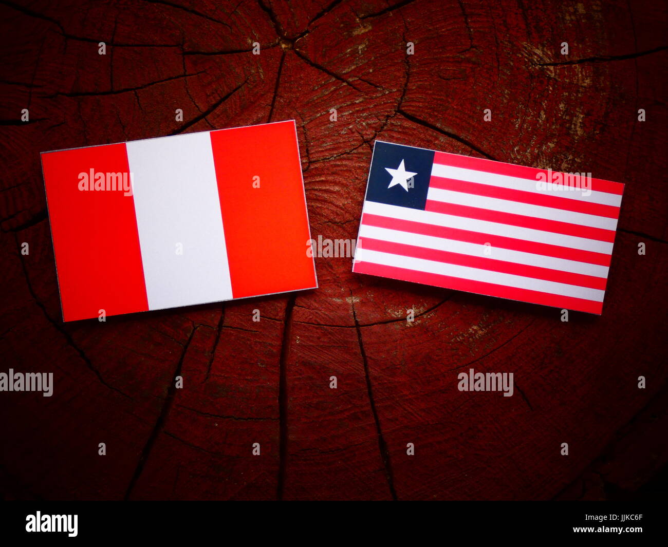 Peruvian flag with Liberian flag on a tree stump isolated Stock Photo ...