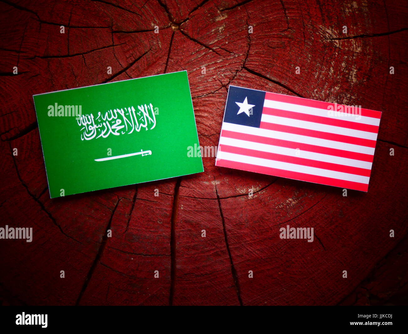 Saudi Arabian flag with Liberian flag on a tree stump isolated Stock ...