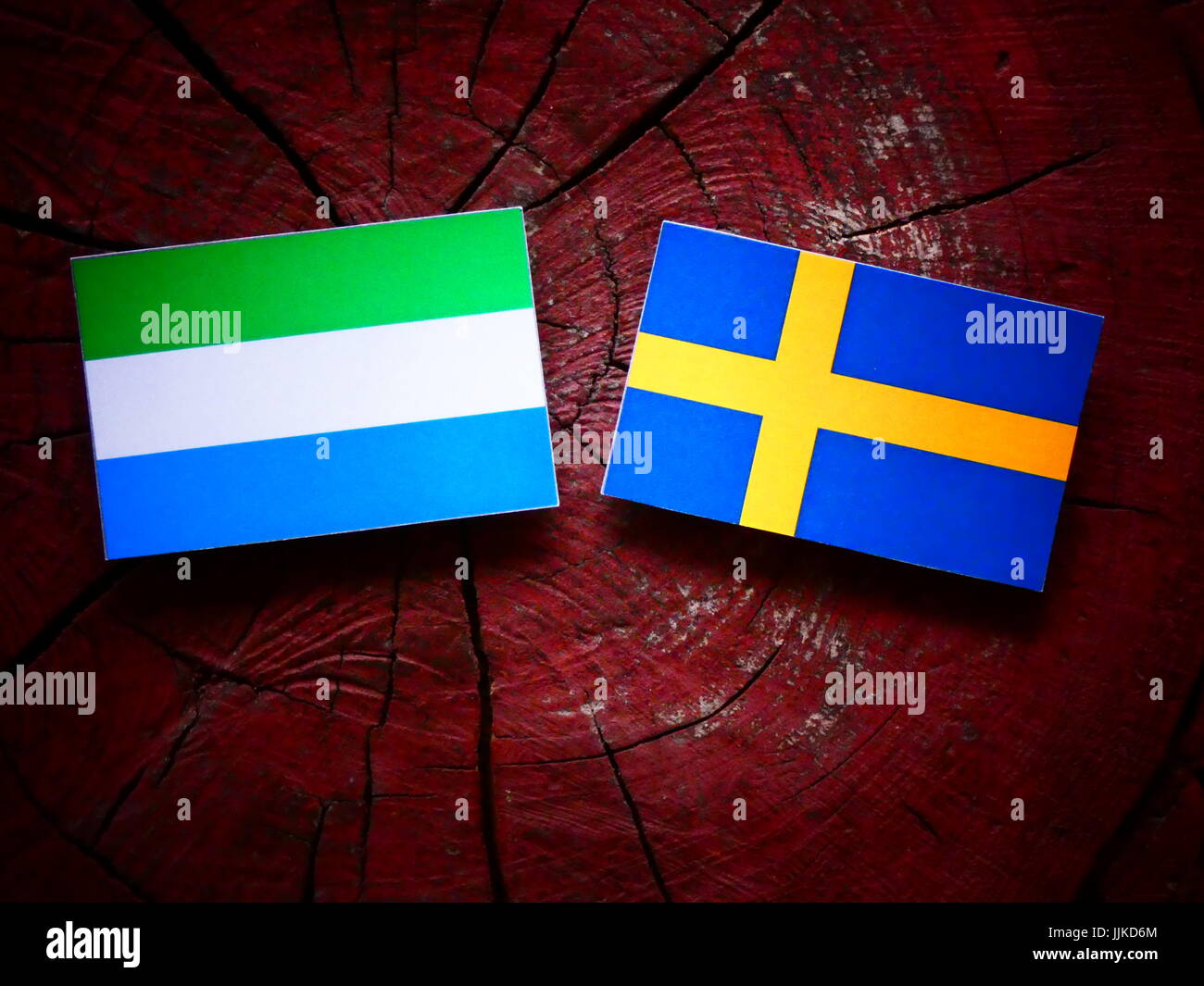 Sierra Leone flag with Swedish flag on a tree stump isolated Stock ...